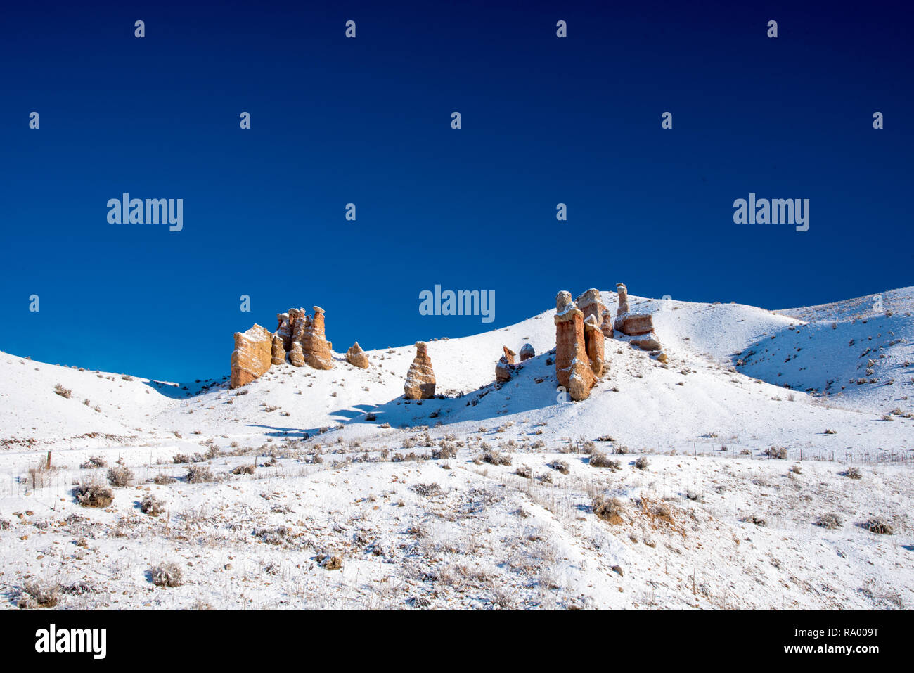 Red rock formation on a snowy hillside. The formation is called, "the ...