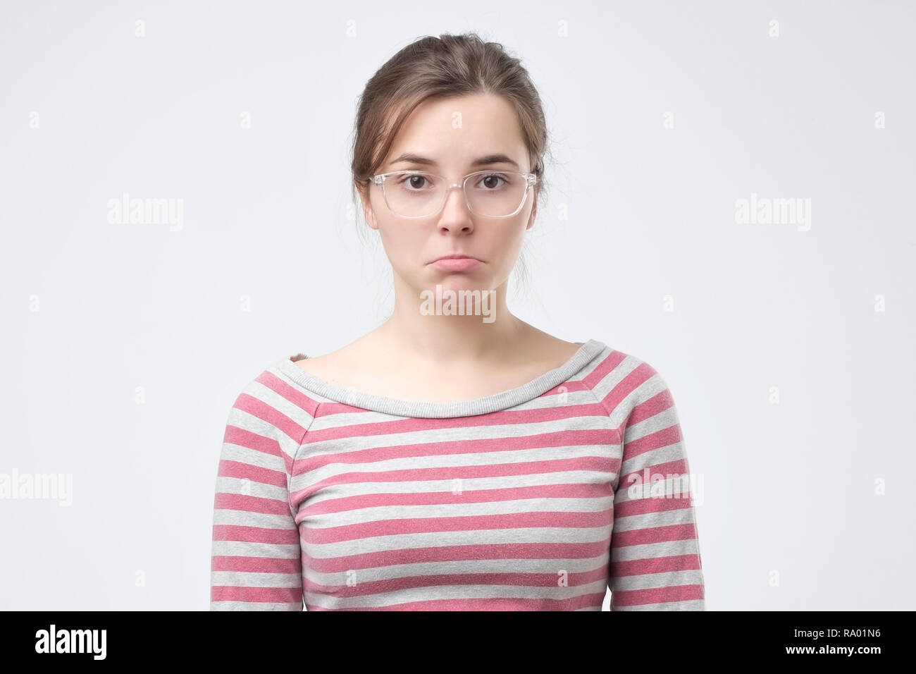 Young beautiful sad woman serious and concerned looking worried and ...
