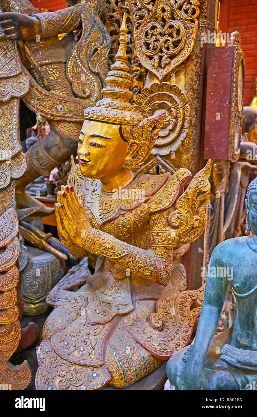 The antique sculpture of praying Nat (Spirit deity), decorated with ...