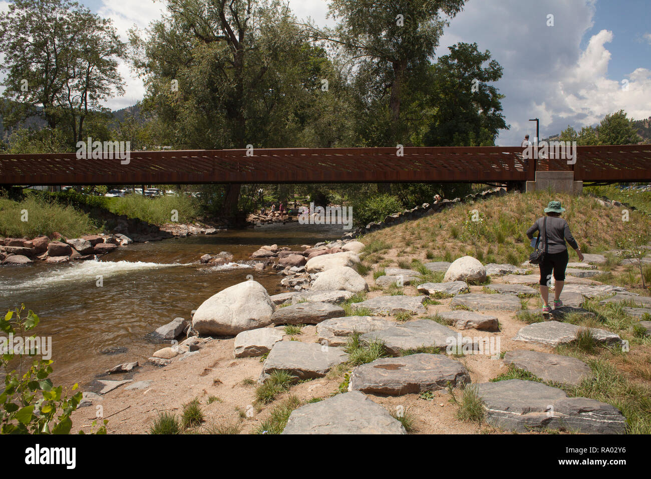 People walk along Boulder Creek which runs through Boulder, Colorado ...
