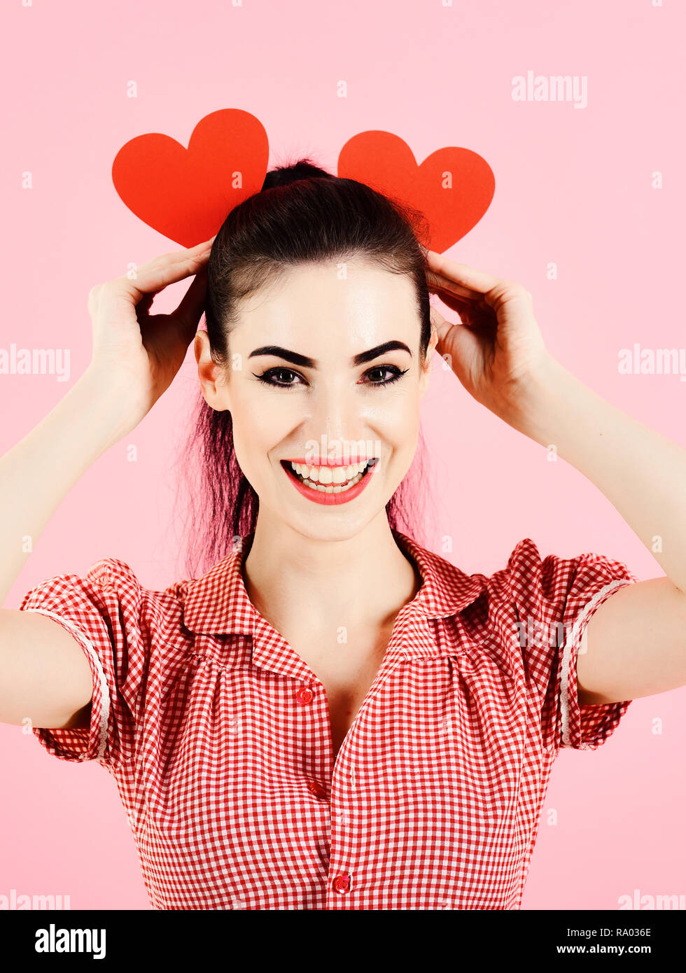 Stupid love concept. Girl looks funny and shows stupid love Stock Photo ...