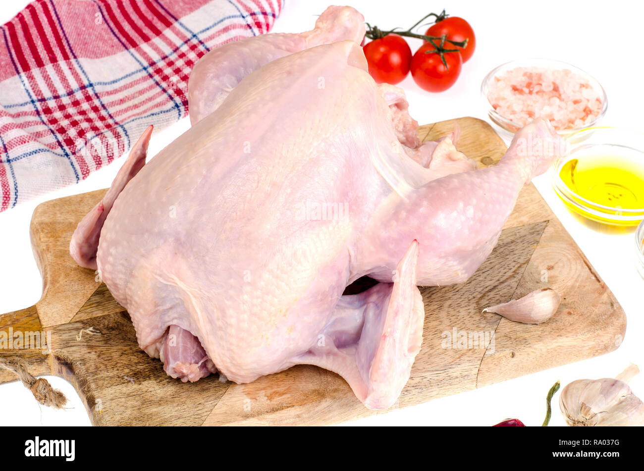 Raw chicken meat with vegetables and spices on cutting board, prepared ...