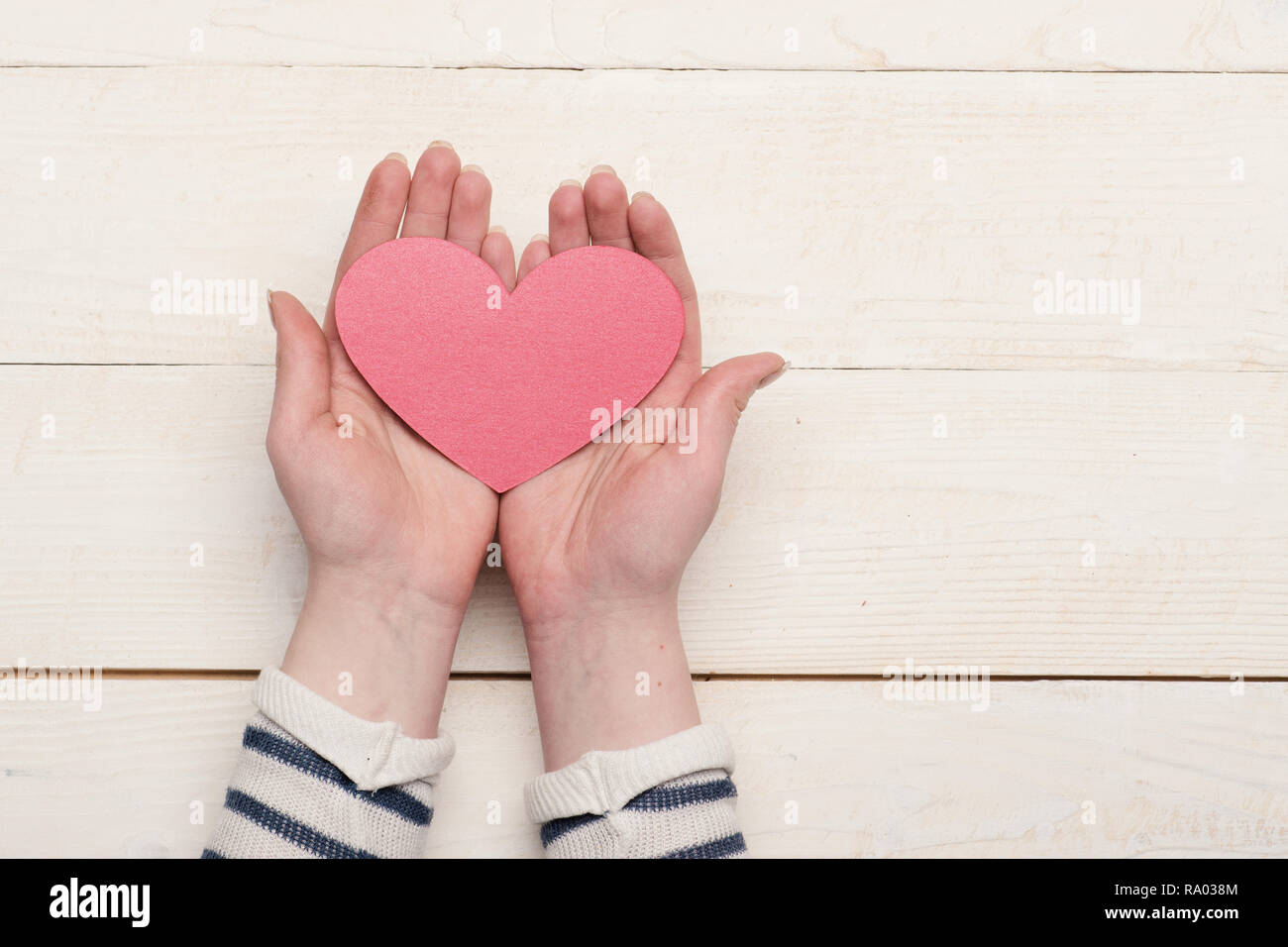 Female hands holding red paper heart. Womans palms with symbol of love ...
