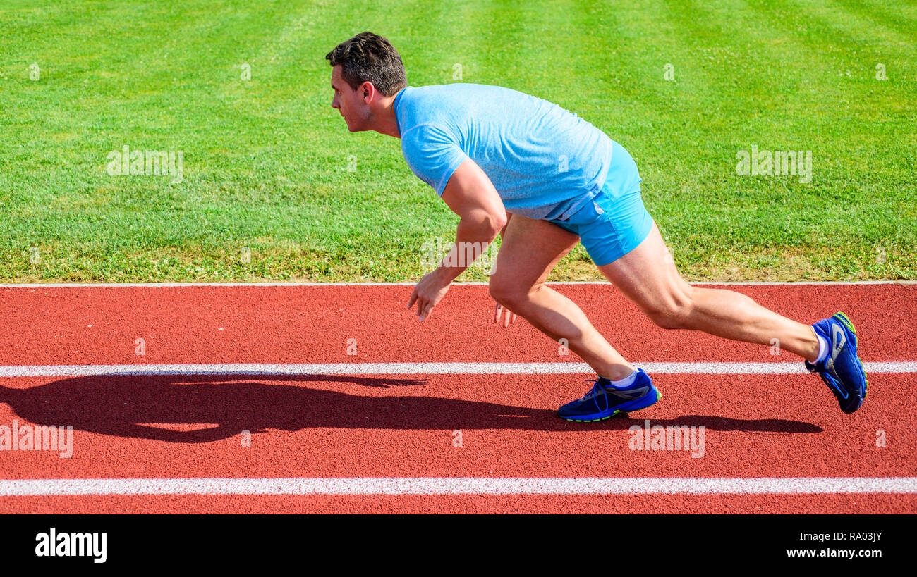Man athlete runner push off starting position stadium path sunny day ...