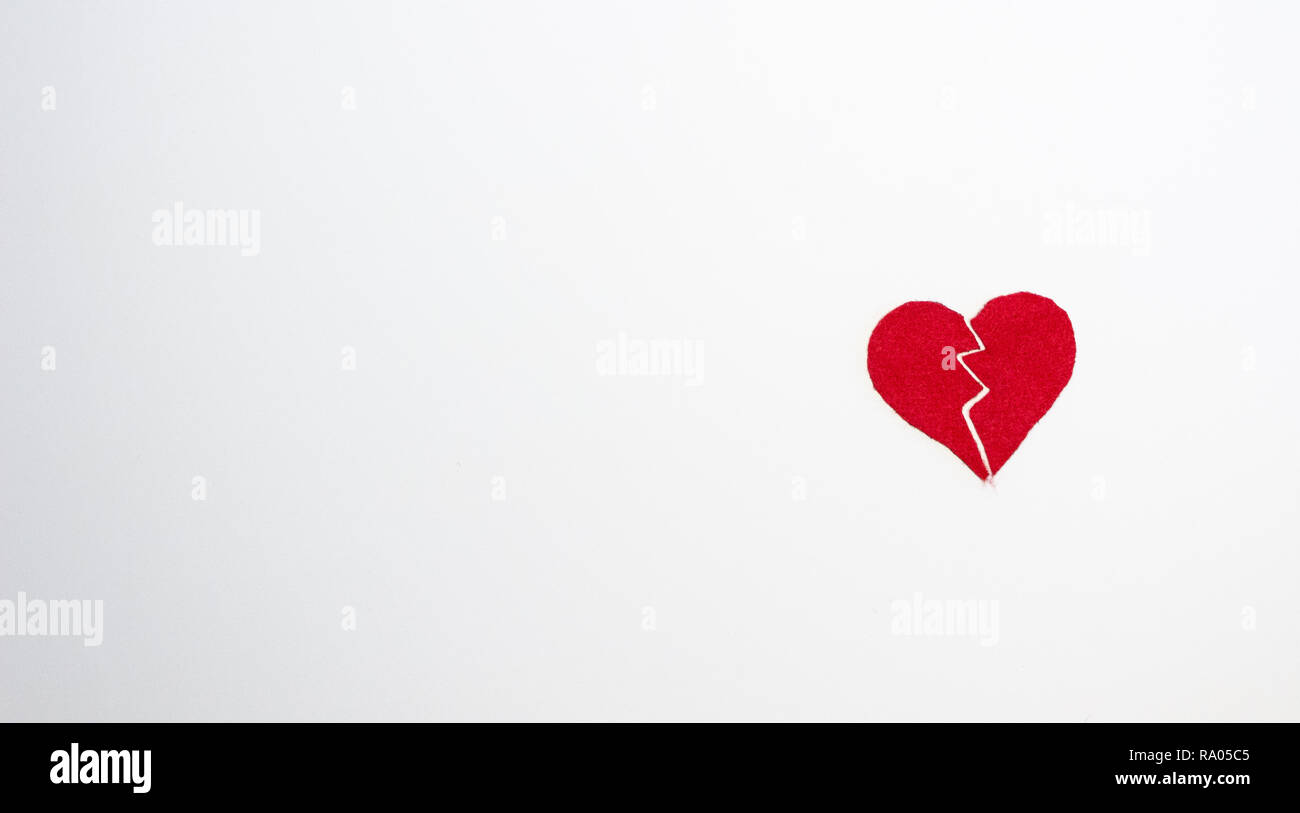 Isolated felt heart broken into two Stock Photo - Alamy