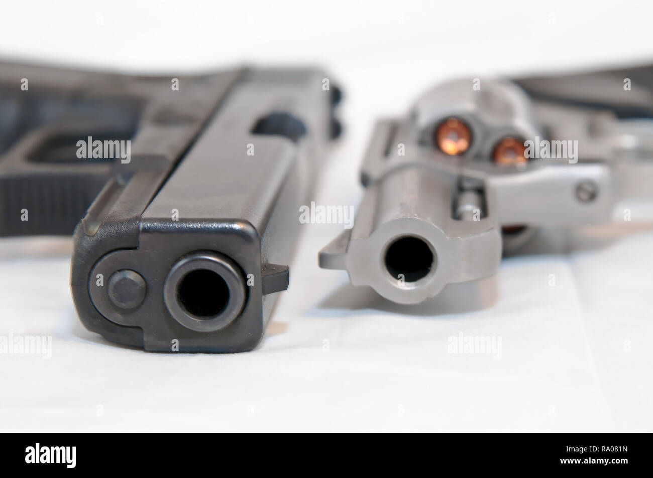 Two handguns, a black 9mm pistol and a silver 357 magnum revolver ...