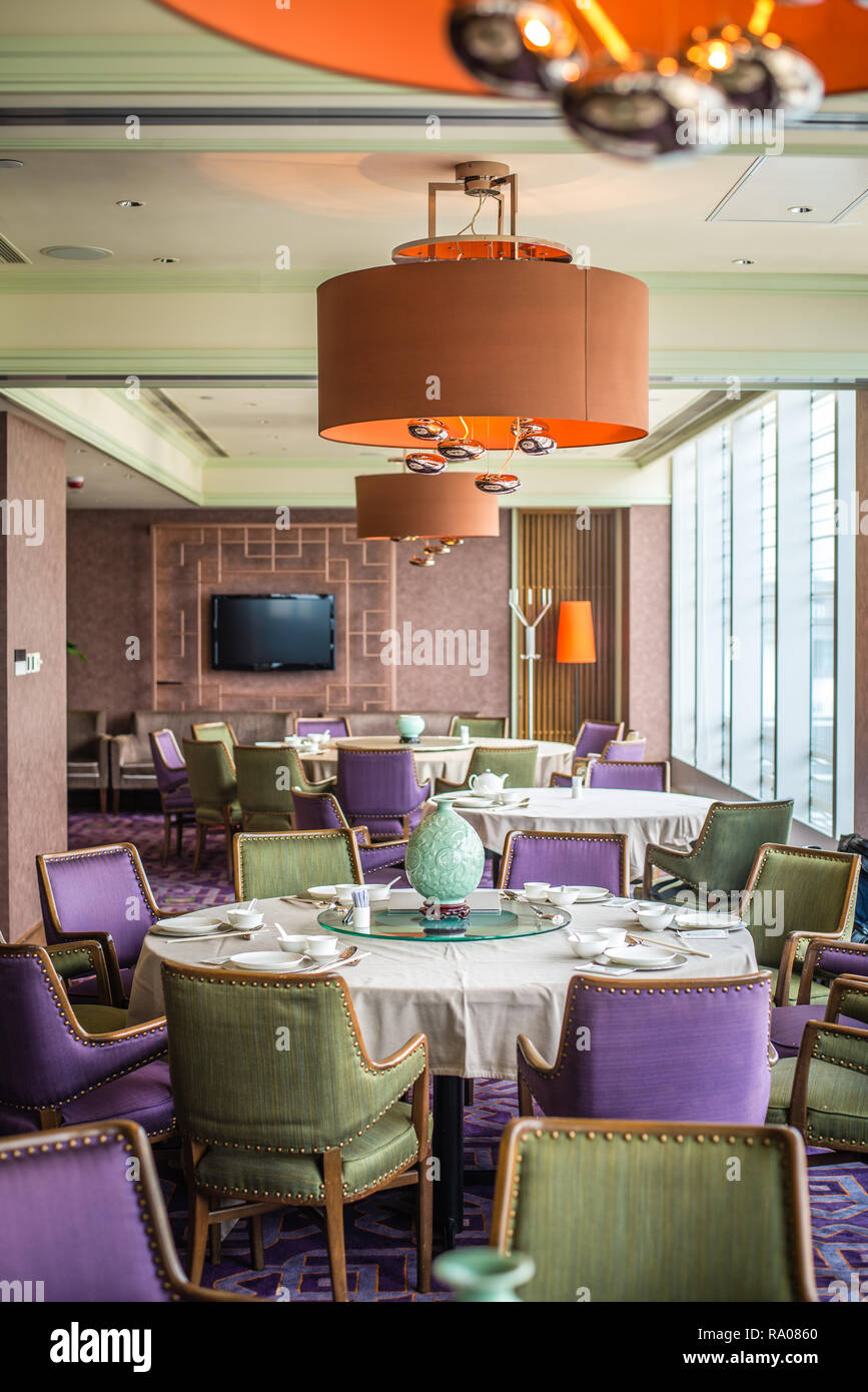 beautiful restaurant interior with round tables and colourful seating ...