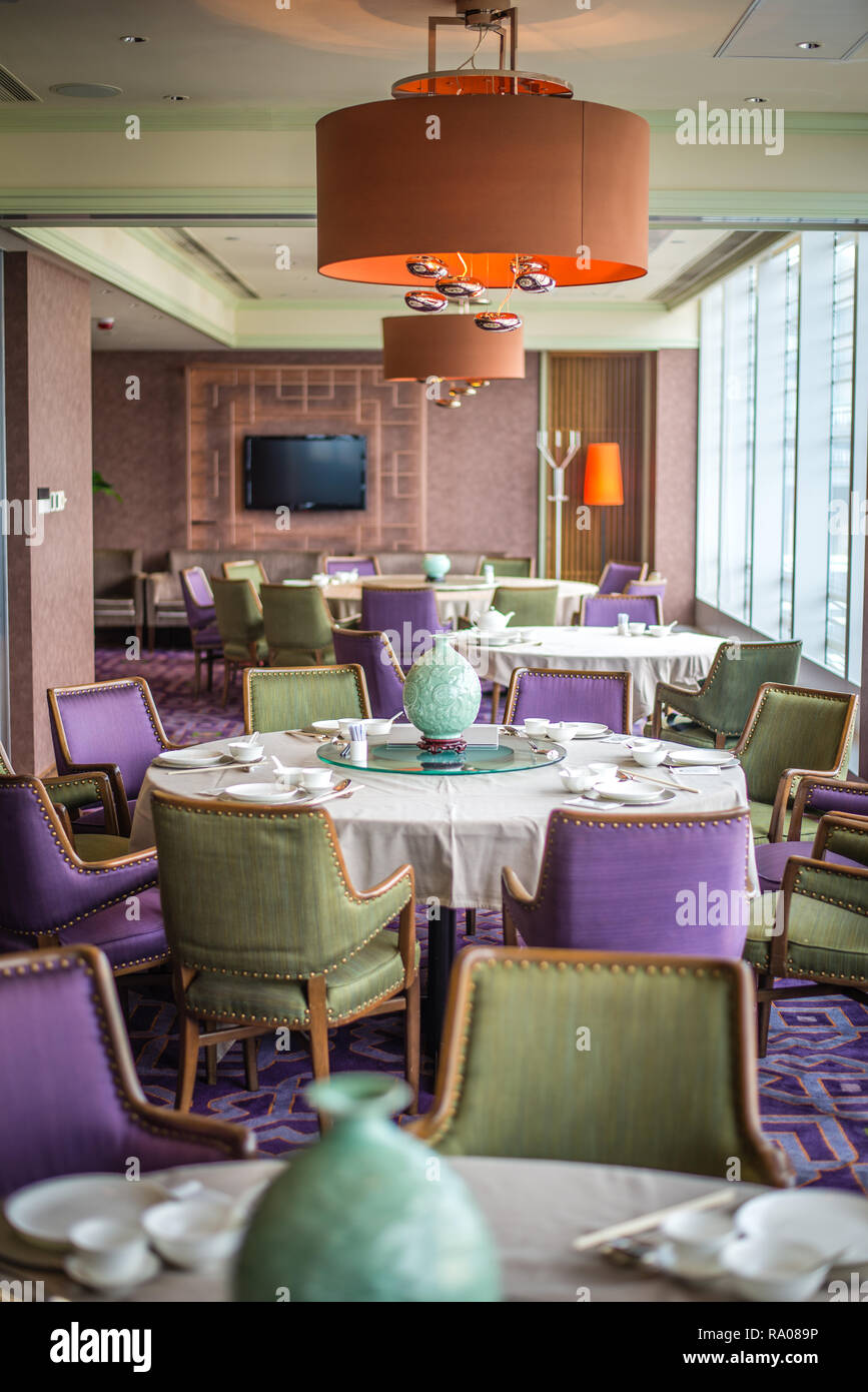 beautiful restaurant interior with round tables and colourful seating ...