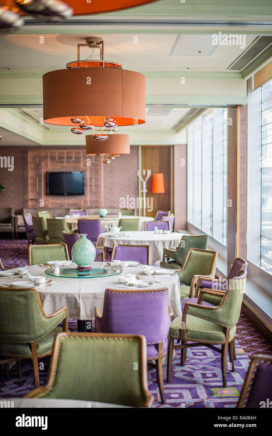 beautiful restaurant interior with round tables and colourful seating ...