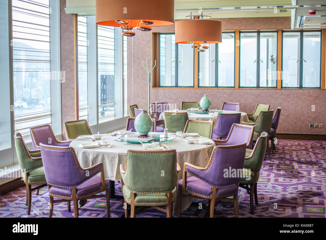 beautiful restaurant interior with round tables and colourful seating ...
