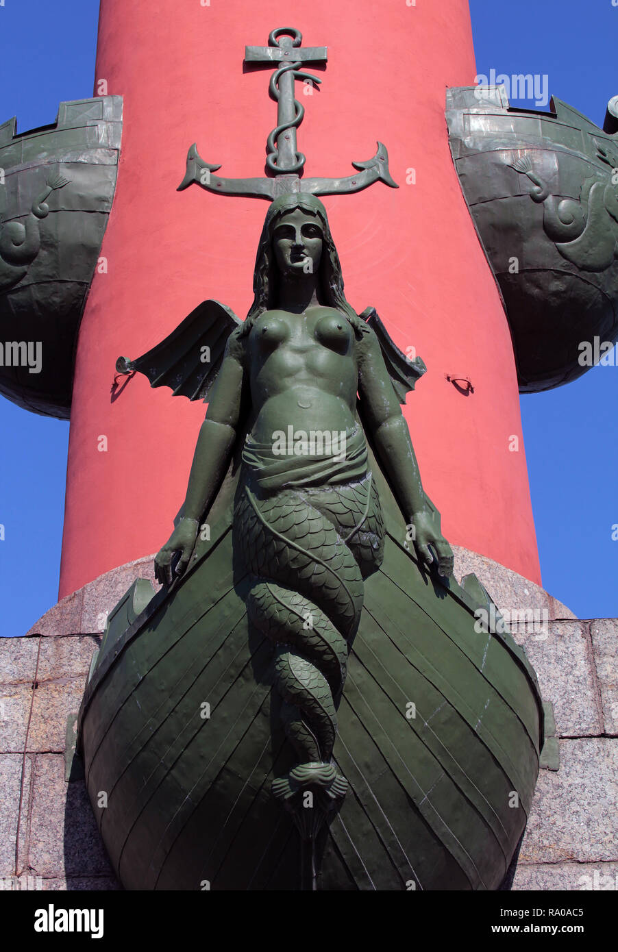 This mermaid figure, on the prow of a boat, sits at the base of one of ...