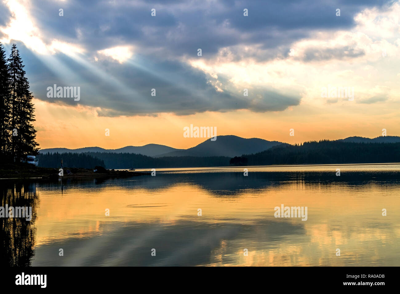 Beautiful sun rays over a dam Stock Photo - Alamy