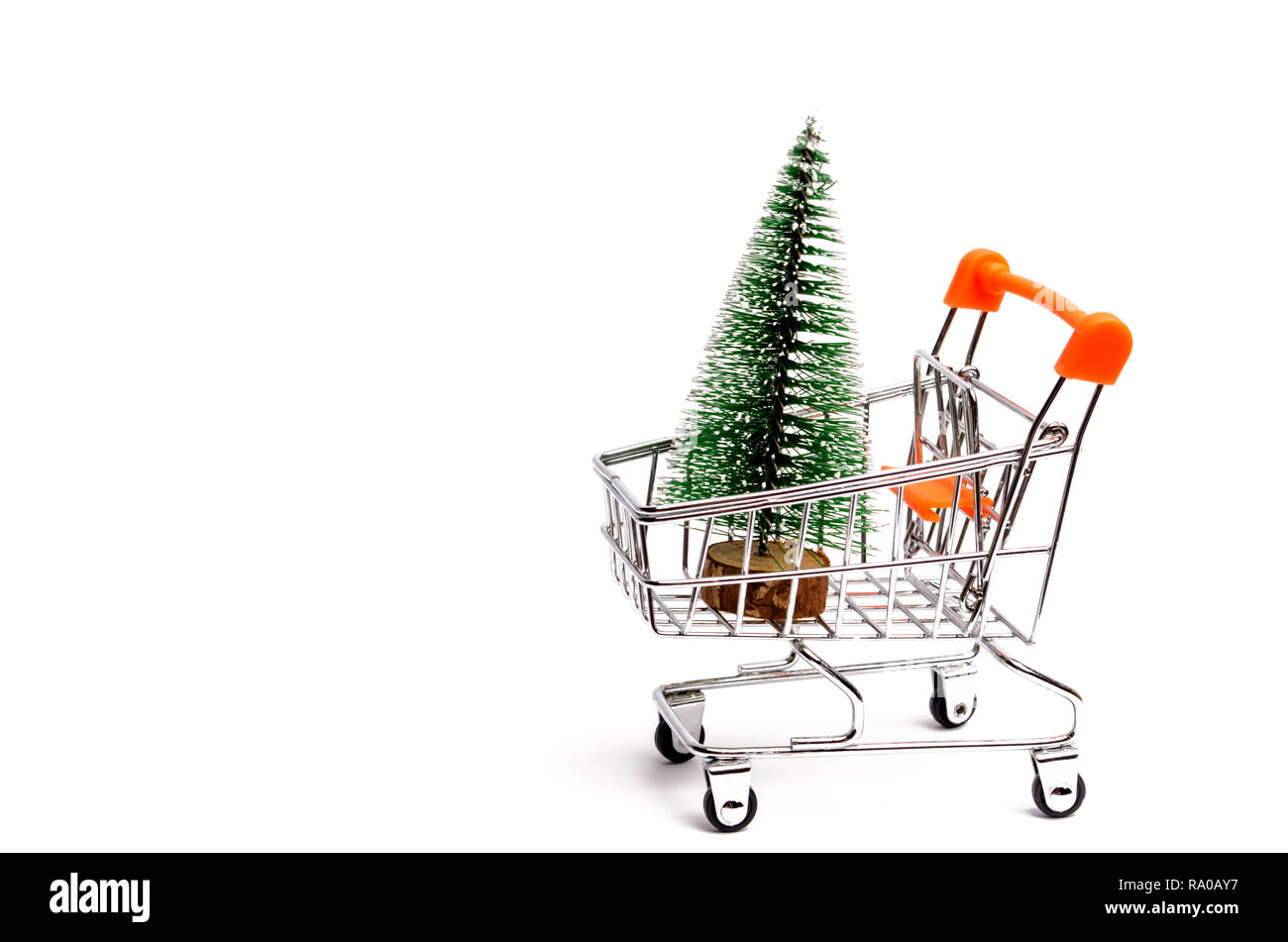 Christmas tree in a supermarket trolley on an isolated white background ...