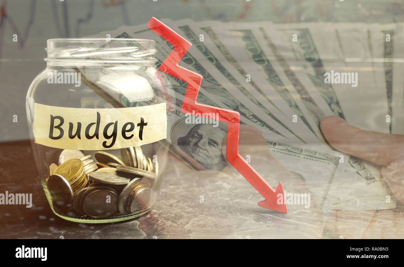 Glass jar and the inscription " Budget " and down arrow. Unsuccessful ...