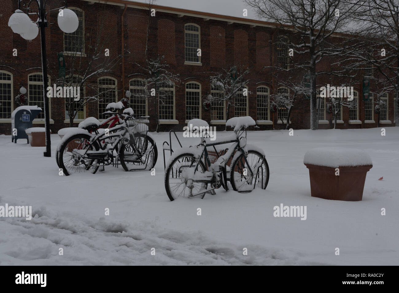 Bicycles in bike racks at mall covered with snow Stock Photo - Alamy