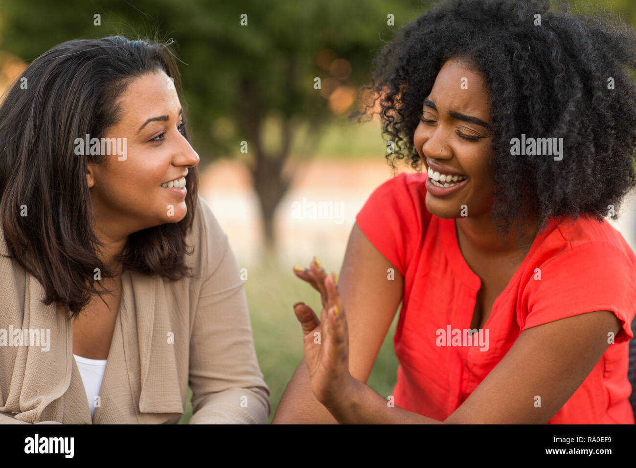 Diverse group of friends talking and laughing Stock Photo - Alamy