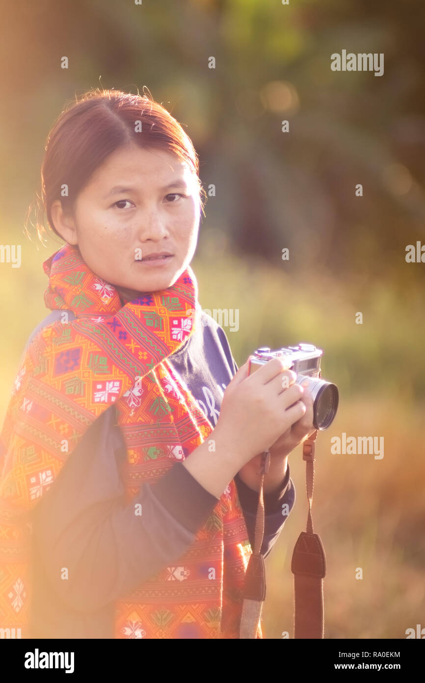 The girl is shooting with the old camera Stock Photo - Alamy