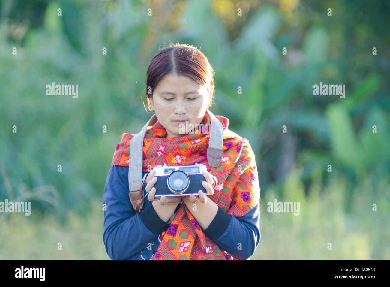 The girl is shooting with the old camera Stock Photo - Alamy