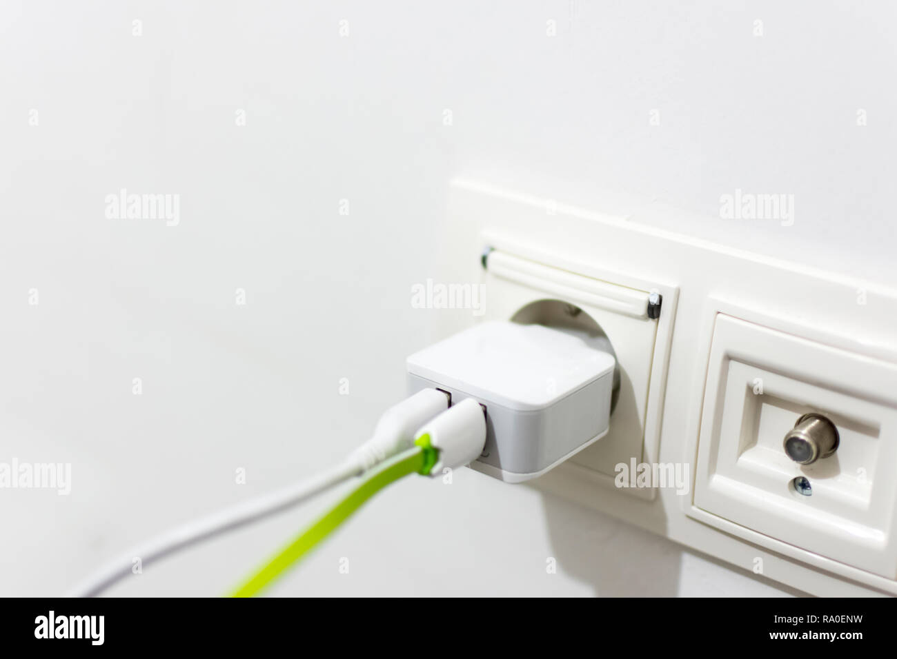Phone charger with two connected cables pluged into the outlet Stock ...