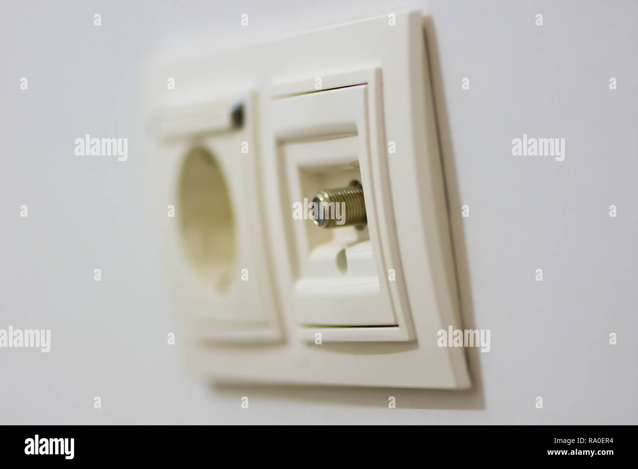 Two sockets connected together on the wall Stock Photo - Alamy