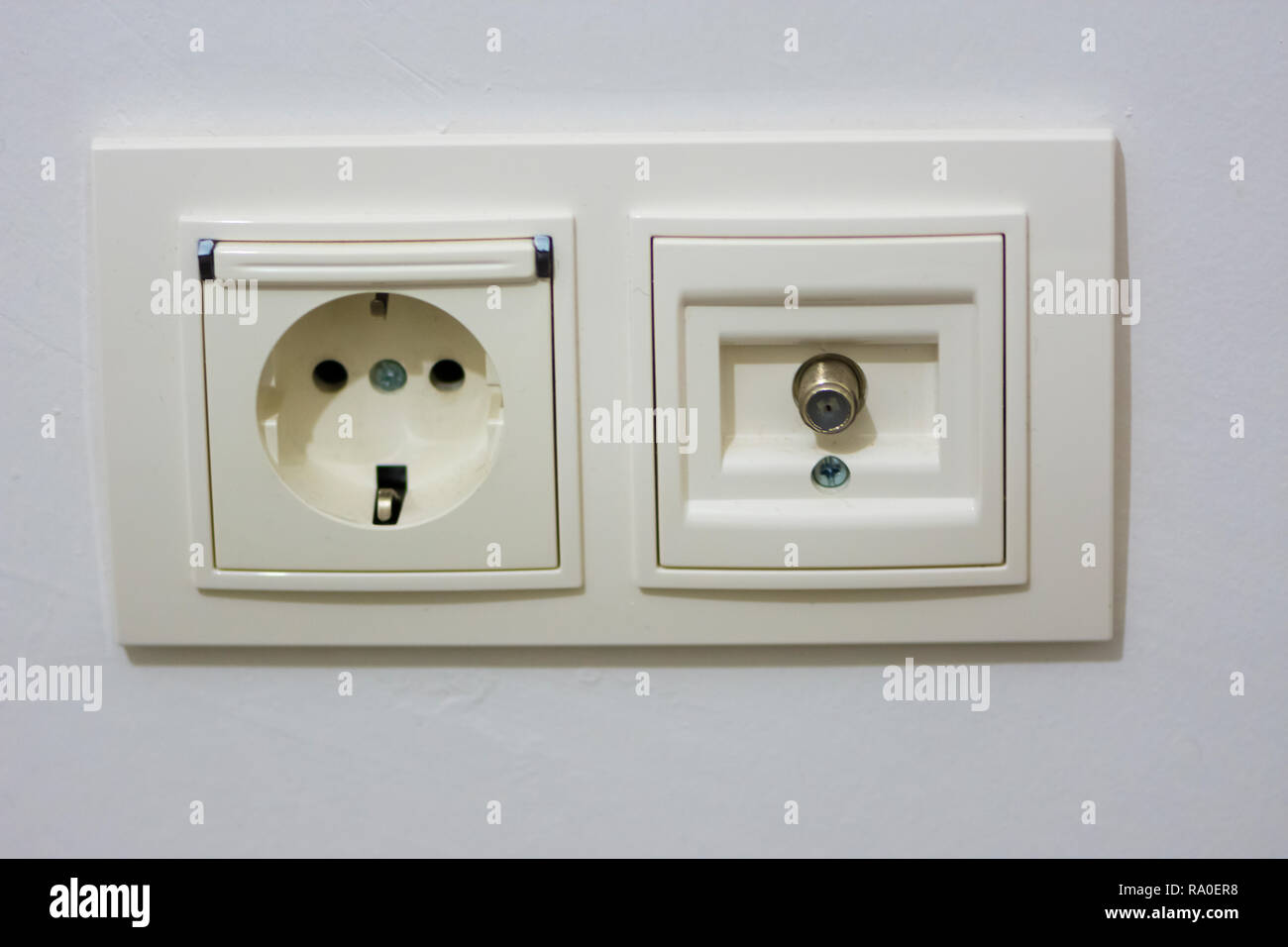 Two sockets connected together on the wall Stock Photo - Alamy