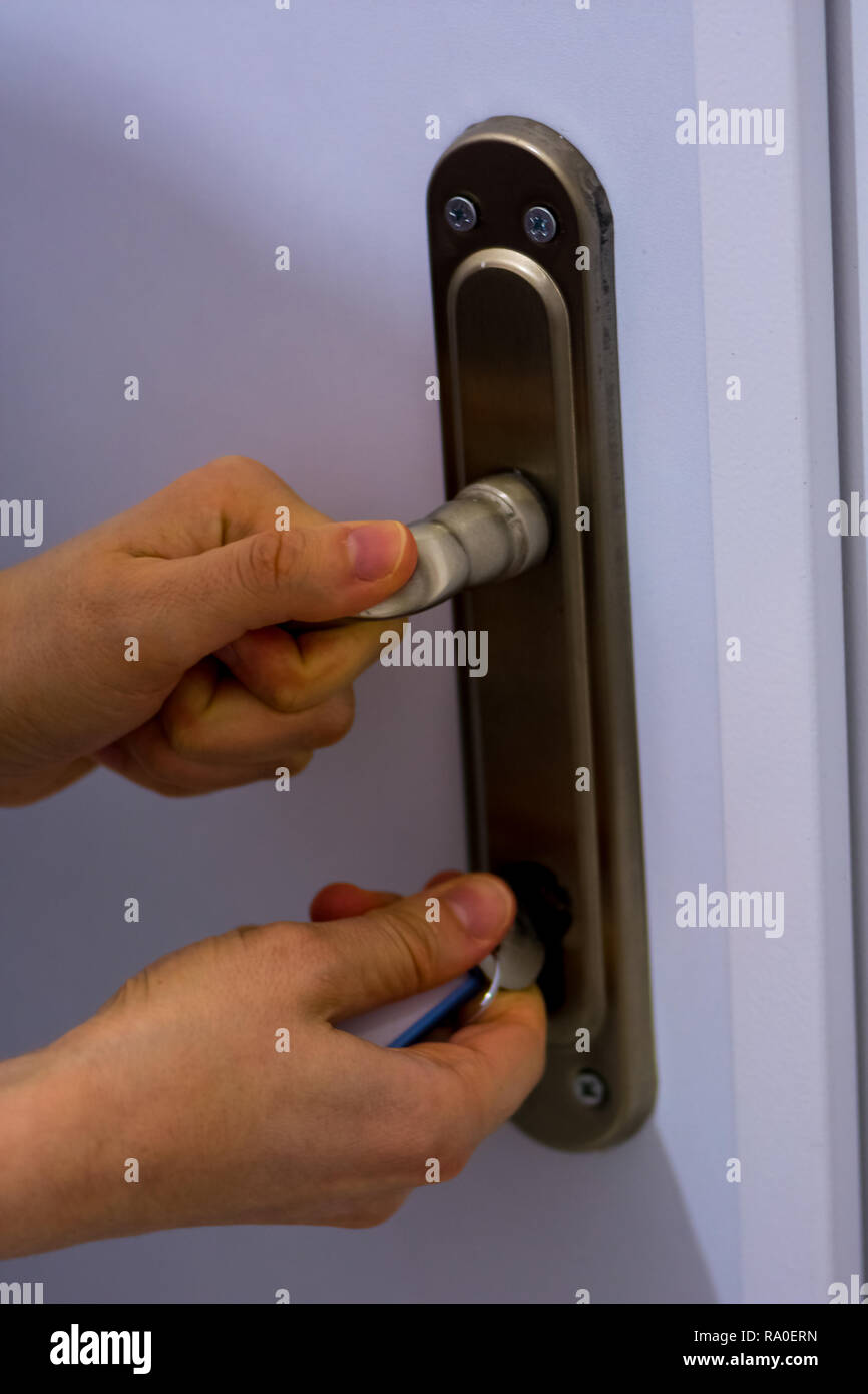 Woman locking the entrance door of her house Stock Photo - Alamy