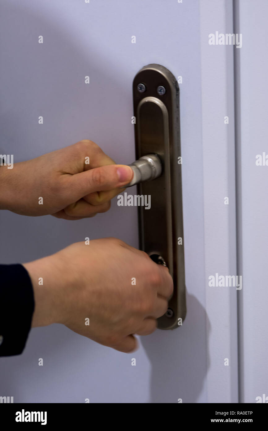 Woman locking the entrance door of her house Stock Photo - Alamy