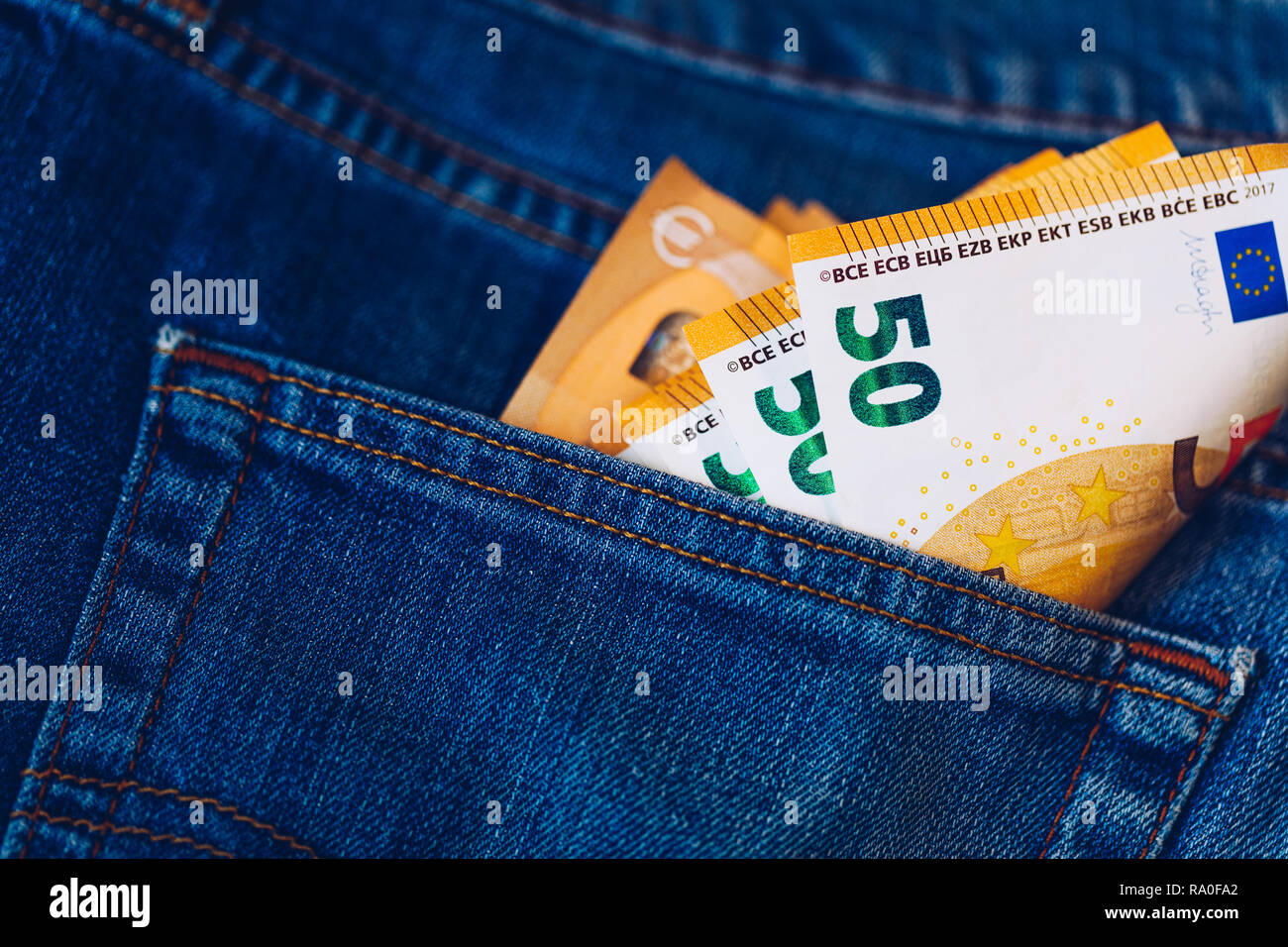 Euro bills in jeans pocket background. Euro banknotes in jeans back ...