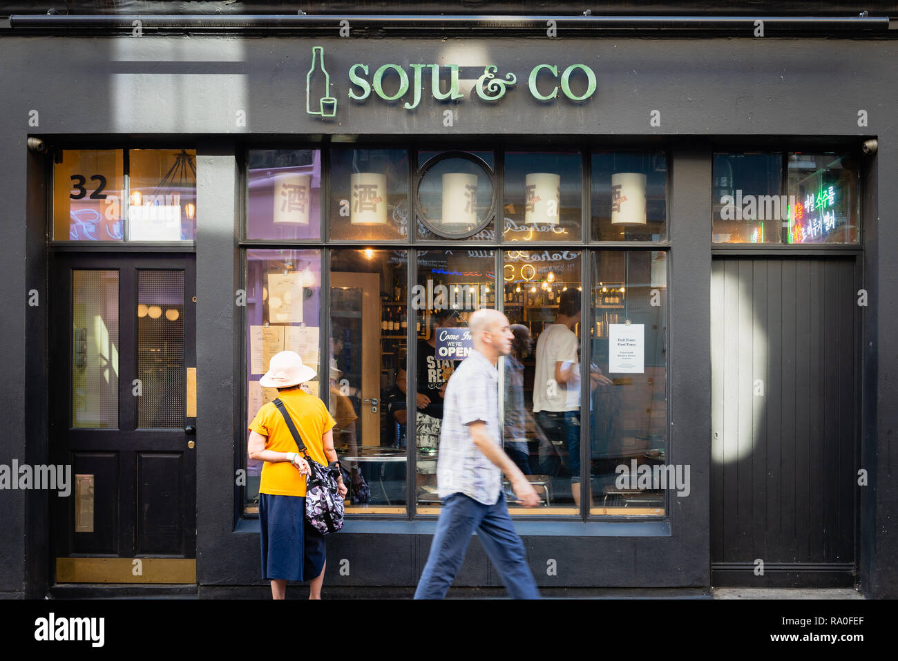 People walking past a cafe in Soho, London Stock Photo - Alamy