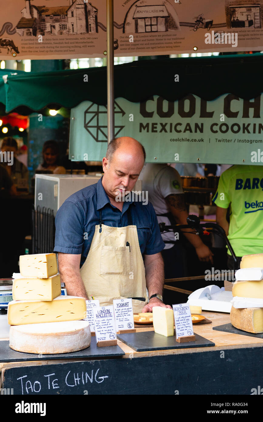 Cheese stall vendor at Borough Market, London Stock Photo - Alamy