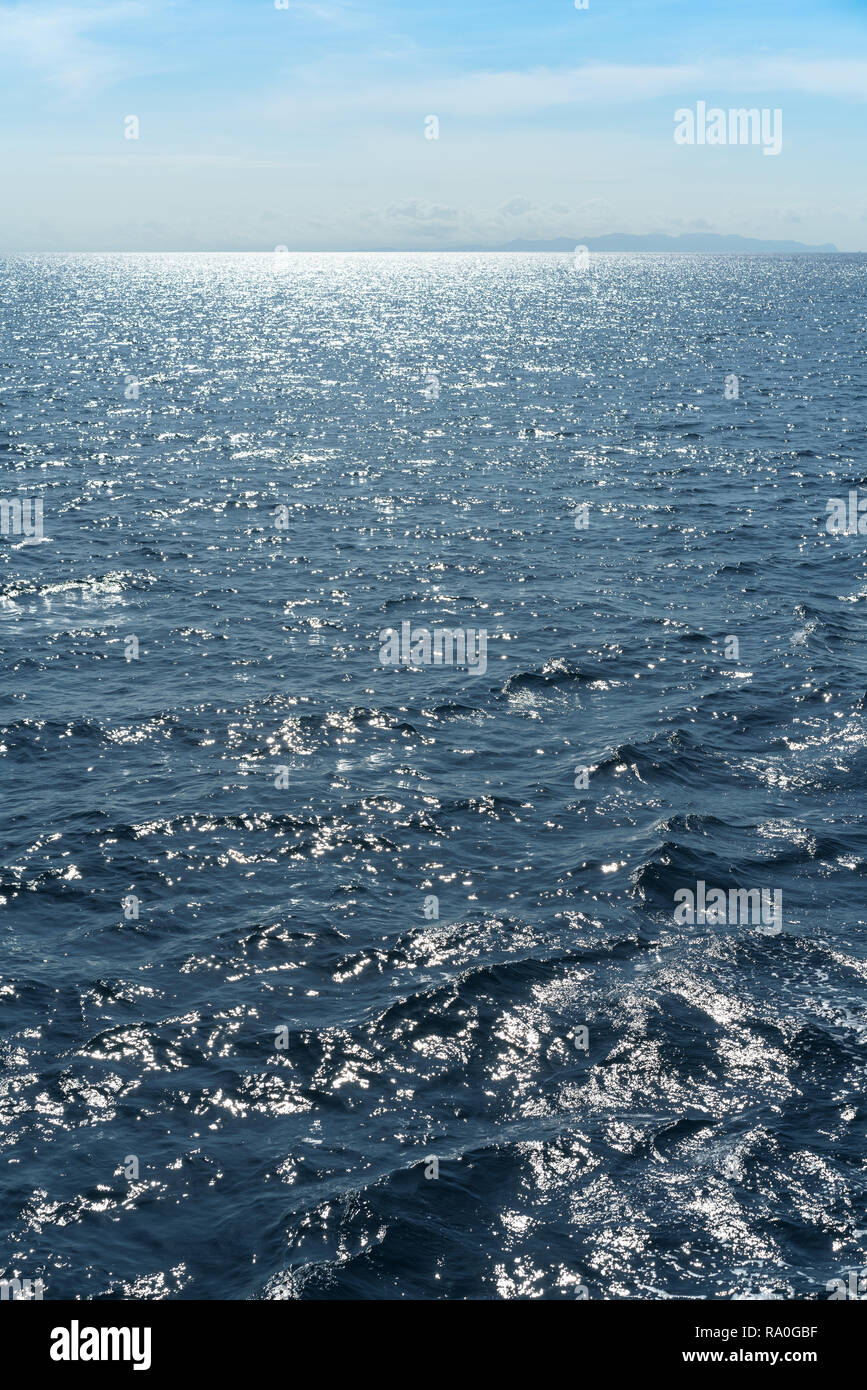 Calm day in the ocean with a blue sky Stock Photo - Alamy