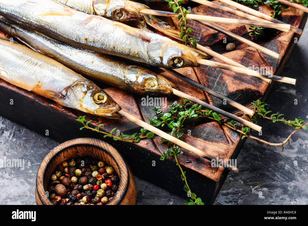 Smoked fish with spices.Cold smoked fish.Smoked capelin.Food industry ...