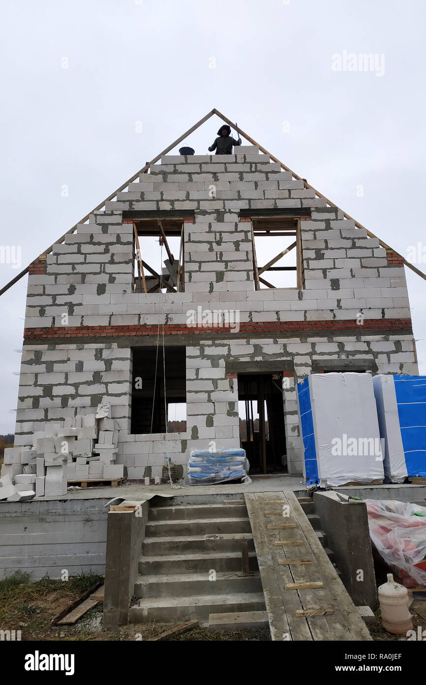 building a house in a village with blocks and bricks on the background ...