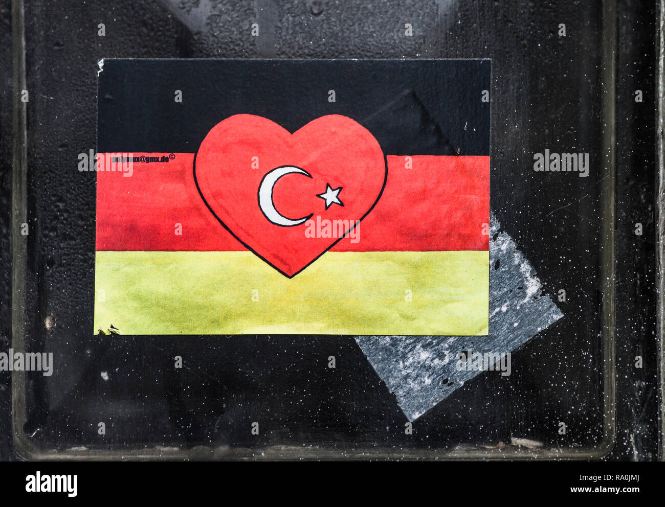 sticker showing the german flag with an applicated heart in the colours ...