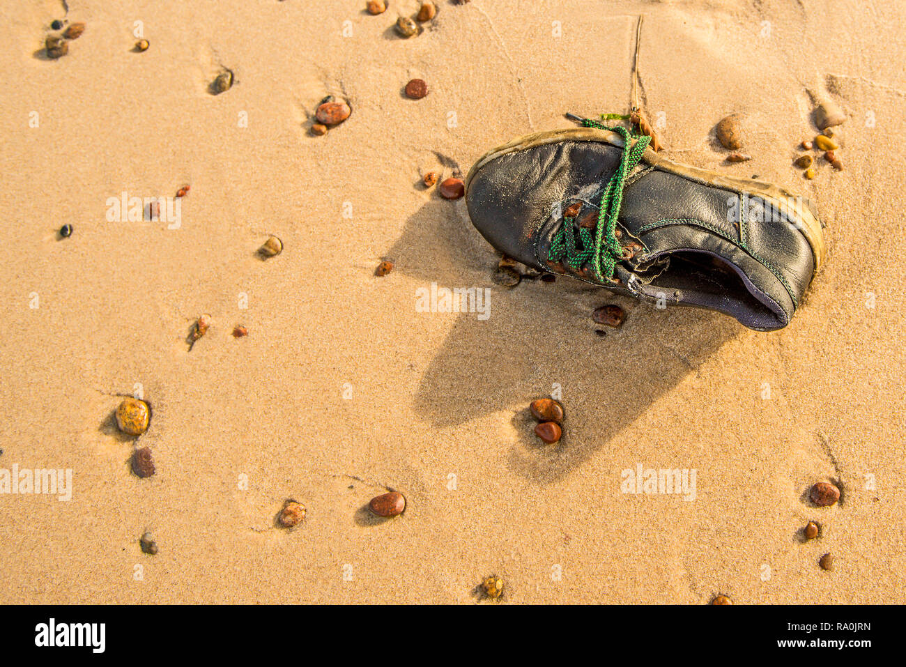 old, lost shoe on a beach Stock Photo - Alamy
