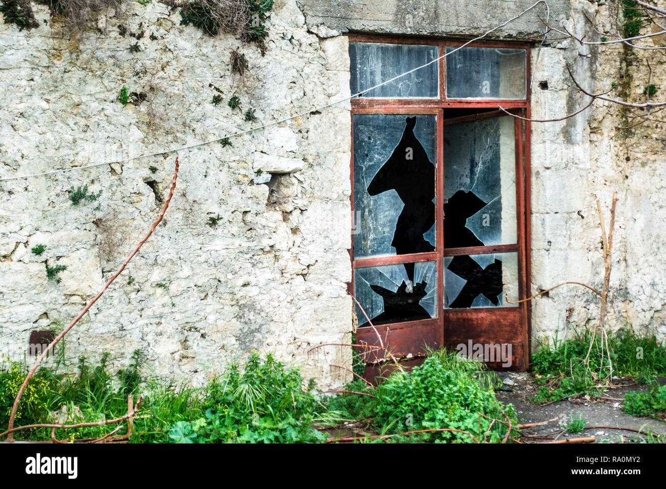 Broken glass door in old ruins at Crete Greece Europe Stock Photo - Alamy