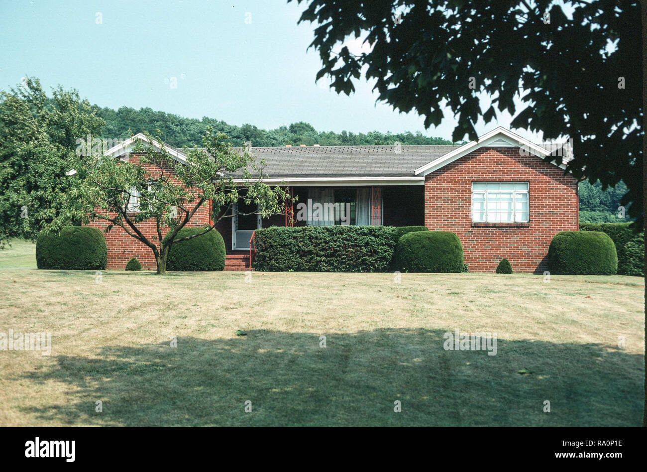Modest ranch style brick house in the northeast in summer, Pennsylvania ...