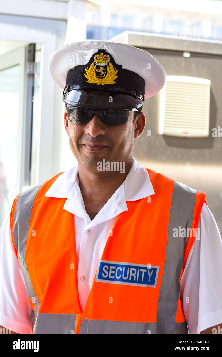 Security member of Cunard Liner Queen Victoria wearing orange tabard hi ...