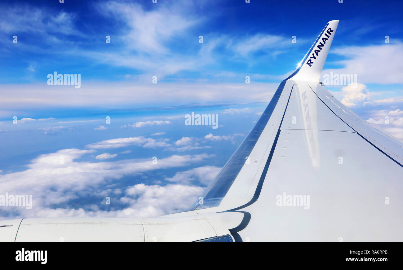 the low cost airline Ryanair - view of the airplane wing and the blue ...
