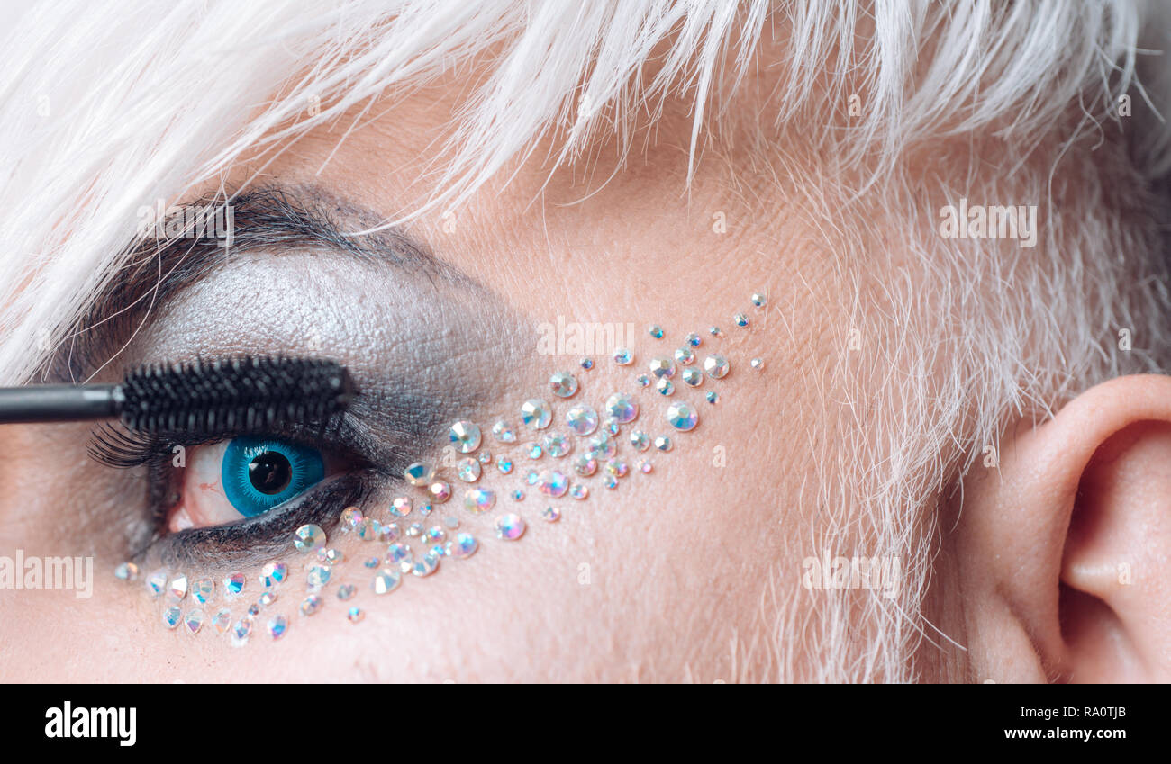 Two layers of mascara. Transgender man apply mascara. Male makeup ...