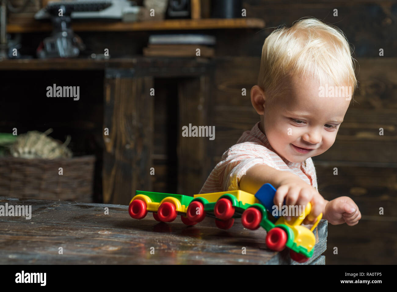 Little kid play with toy train in playschool. Playschool education and ...