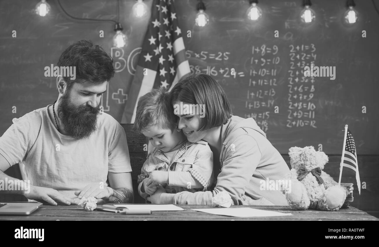 Parents teaching son american traditions playing. Kid with parents in ...