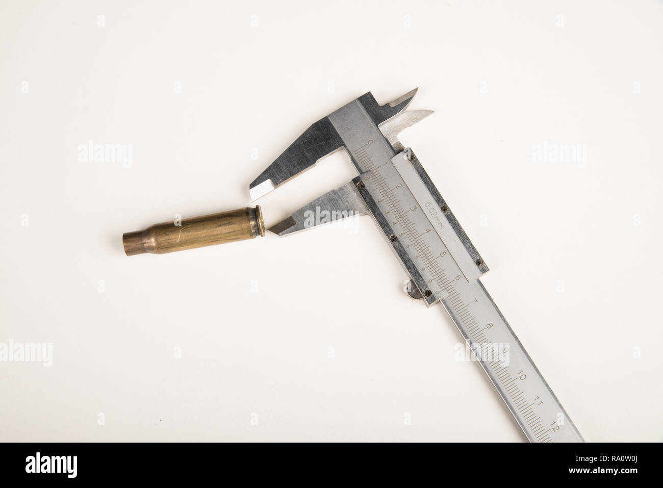 Bullet being measured with a caliper, a concept Stock Photo - Alamy