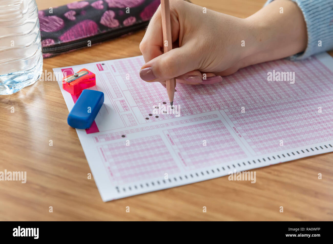 Pencil drawing selected choice on answer sheets. hand fill in Exam ...