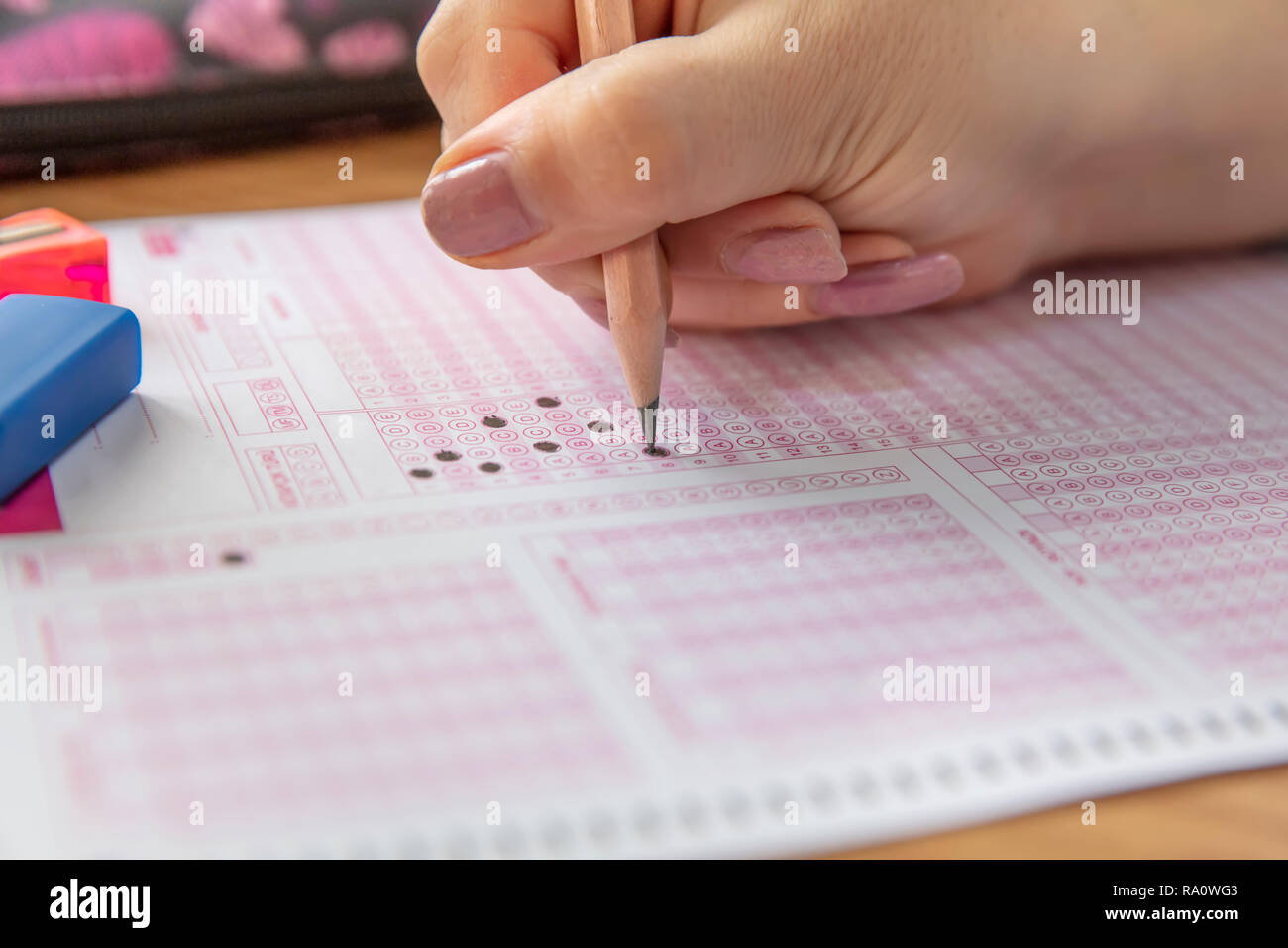 Pencil drawing selected choice on answer sheets. hand fill in Exam ...