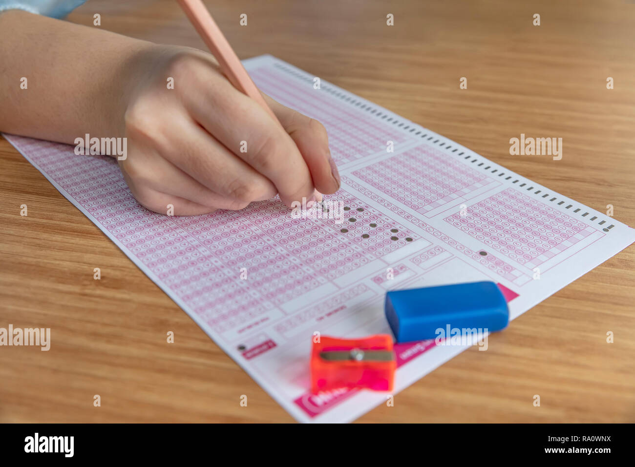 Pencil drawing selected choice on answer sheets. hand fill in Exam ...