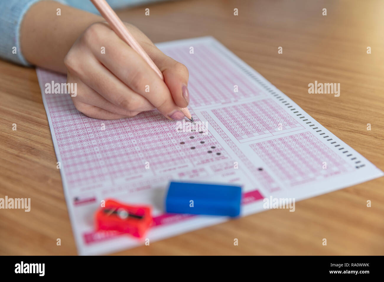 Pencil drawing selected choice on answer sheets. hand fill in Exam ...