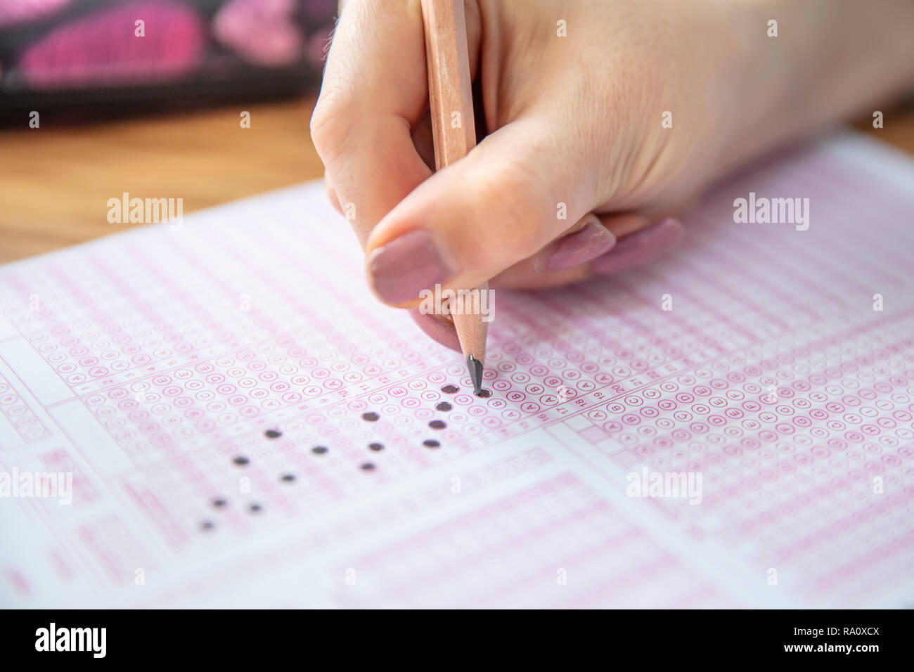 Pencil drawing selected choice on answer sheets. hand fill in Exam ...