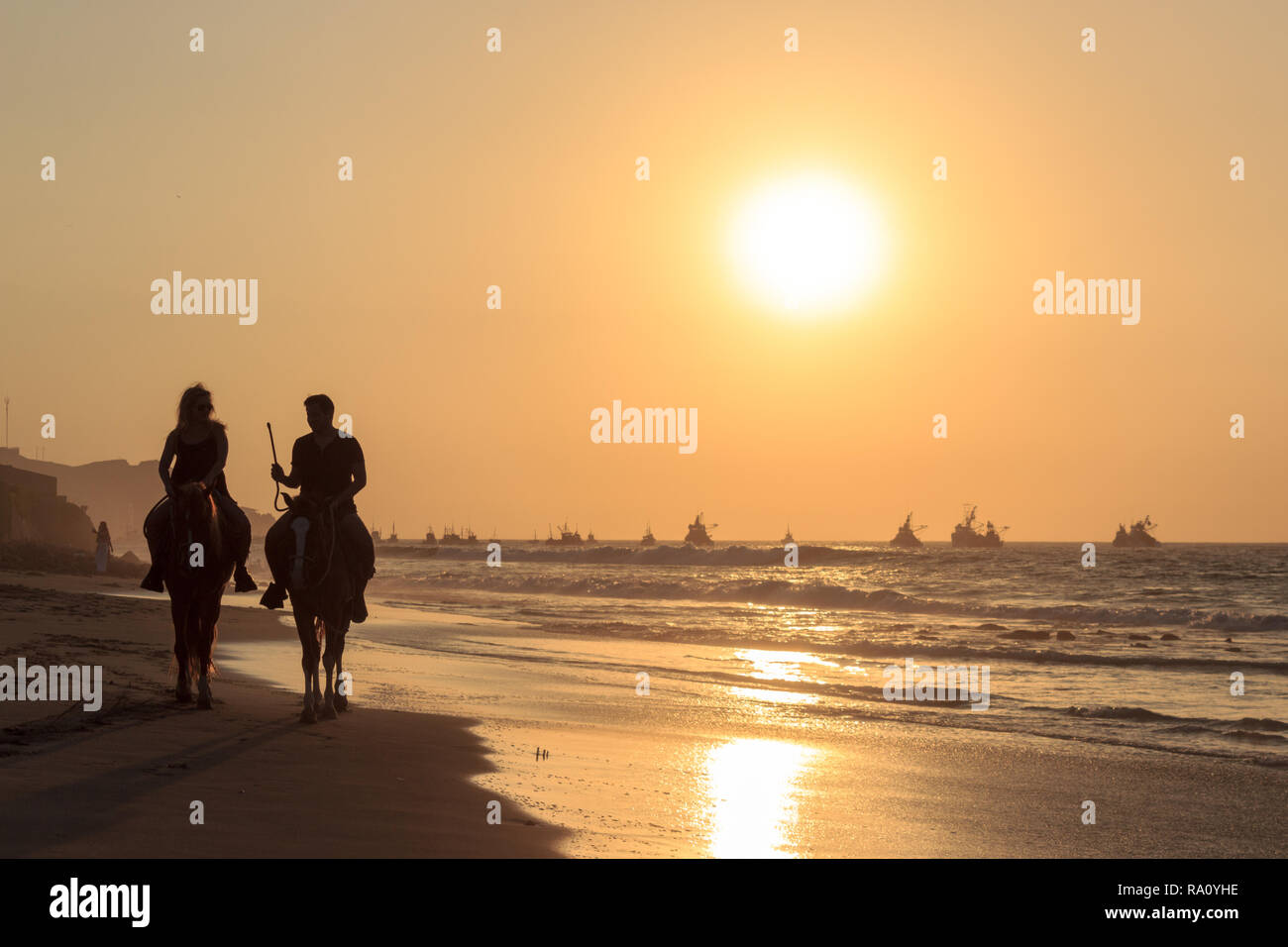 sunset over mancora beach with fisher boats, peru Stock Photo - Alamy