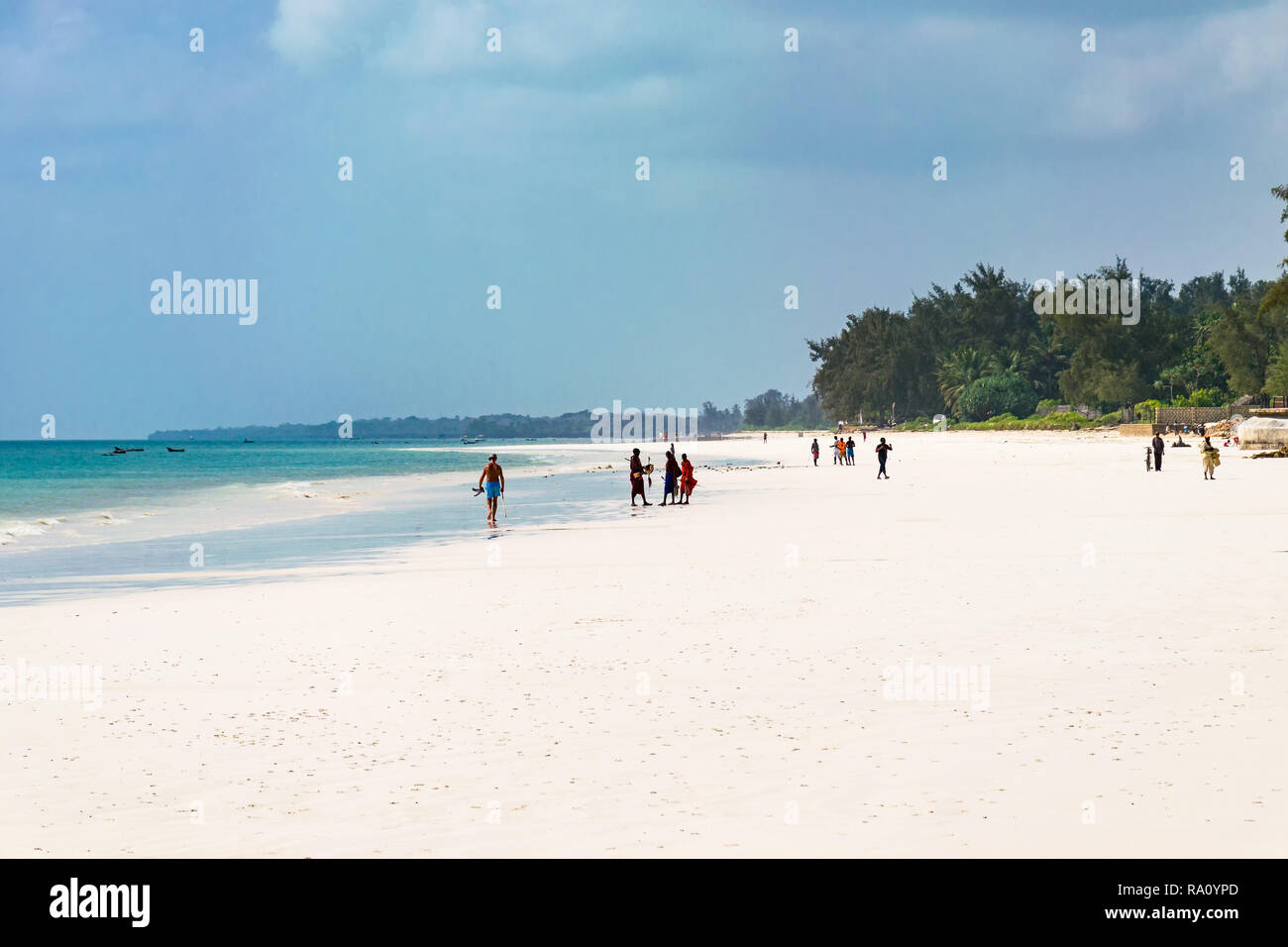 Locals and tourists on the tropical white sand beach of Diani in early ...